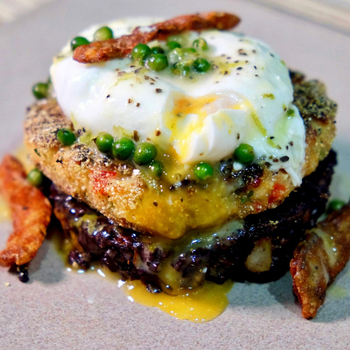 Crispy black rice cake. Fresh salmon patty. Poached egg. Green ...