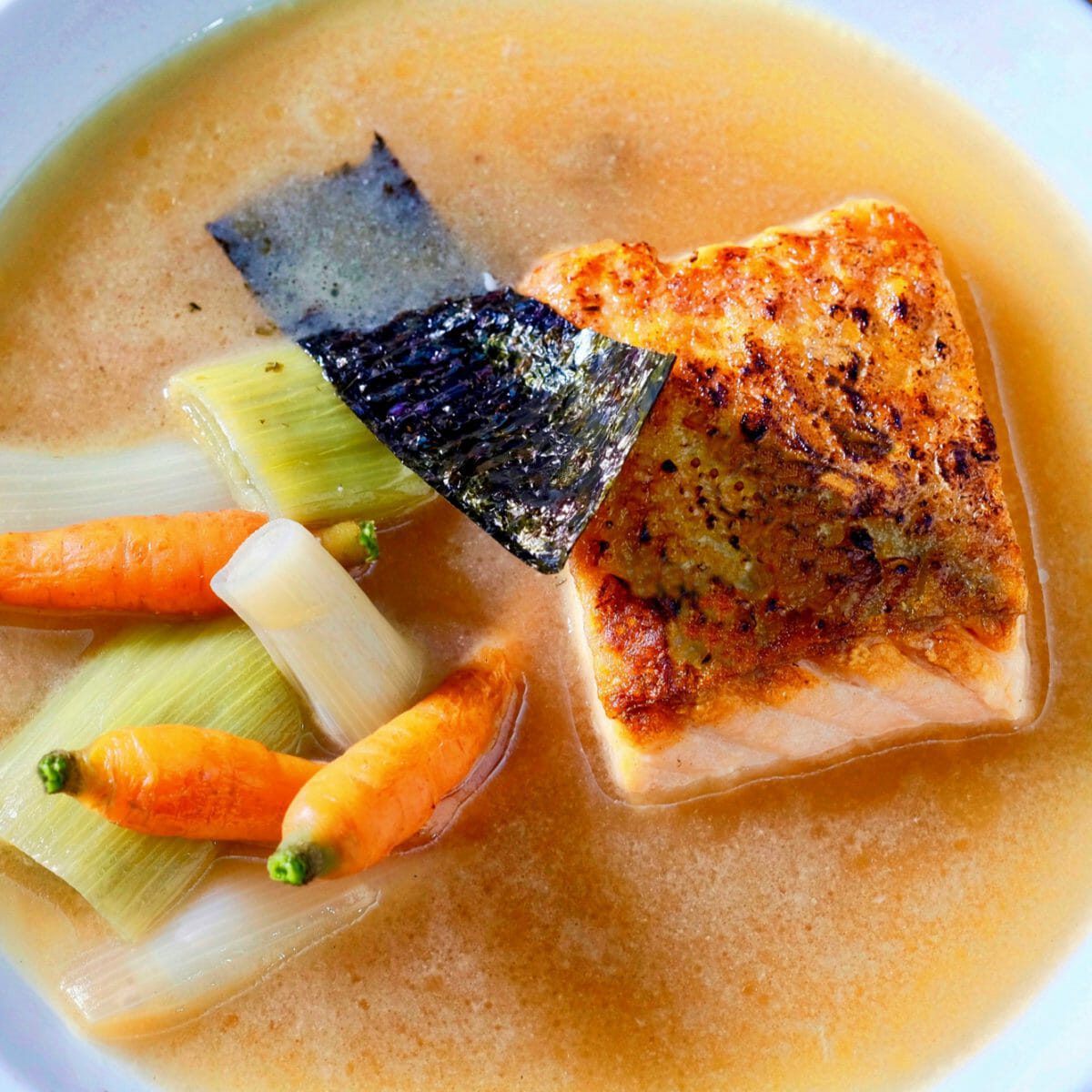 Salmon poached in miso dashi with leeks and baby carrots - delectabilia
