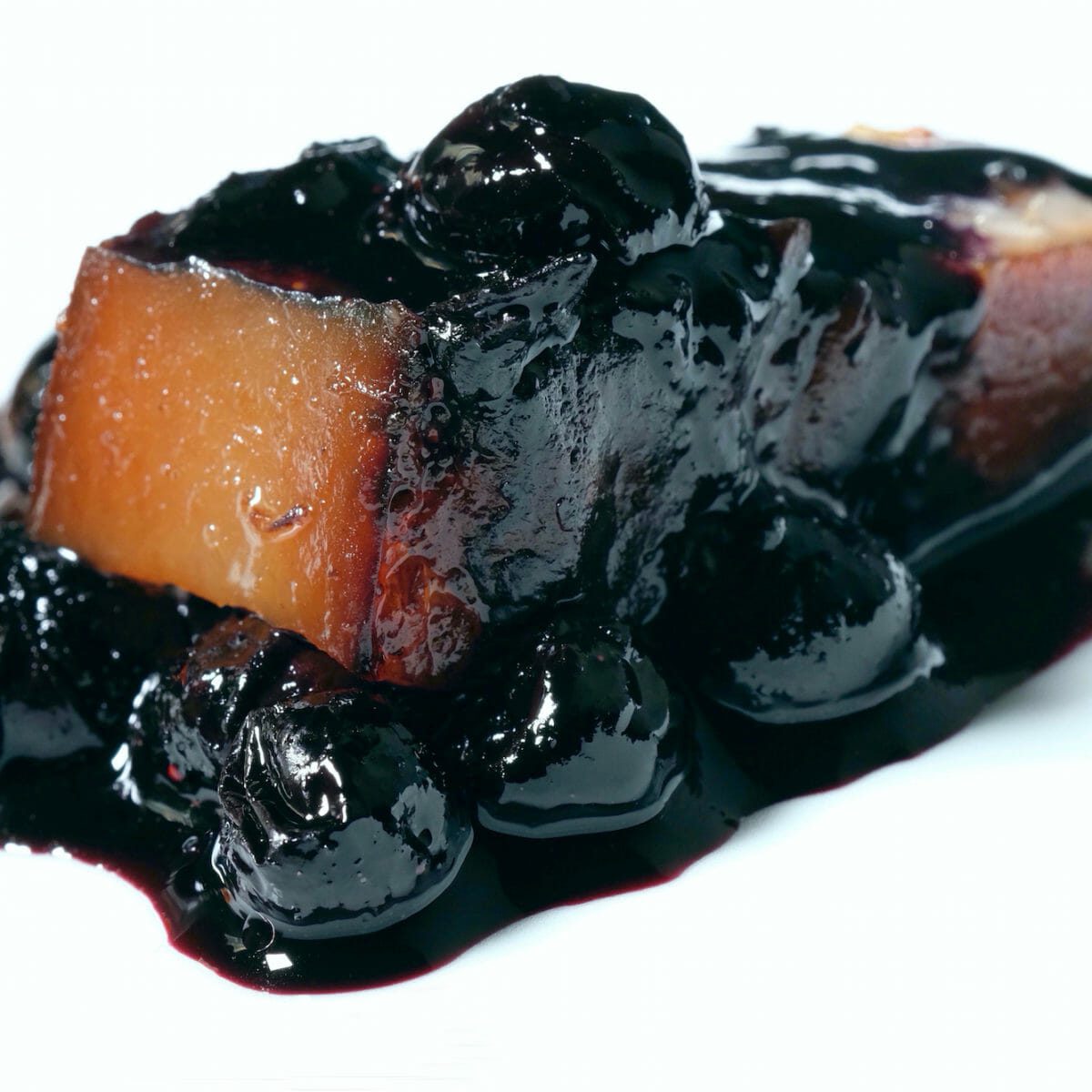 Pork belly sous vide with a blueberry reduction - delectabilia
